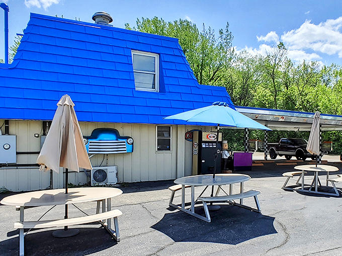 The iconic blue-roofed drive-in stands like a sapphire against the Minnesota sky, beckoning hungry travelers with retro charm.