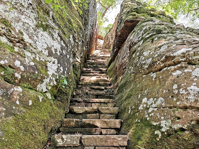 Ancient stone steps carved between towering rock walls invite adventurers into a world that feels more fantasy novel than Illinois landscape.