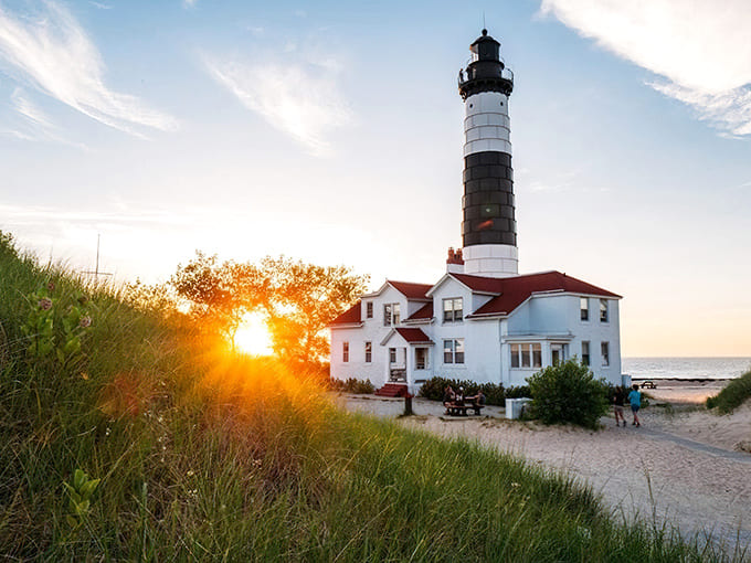 Golden hour at Big Sable Point transforms this 1867 lighthouse into pure magic, with the keeper's quarters looking like they're auditioning for a coastal living magazine cover.