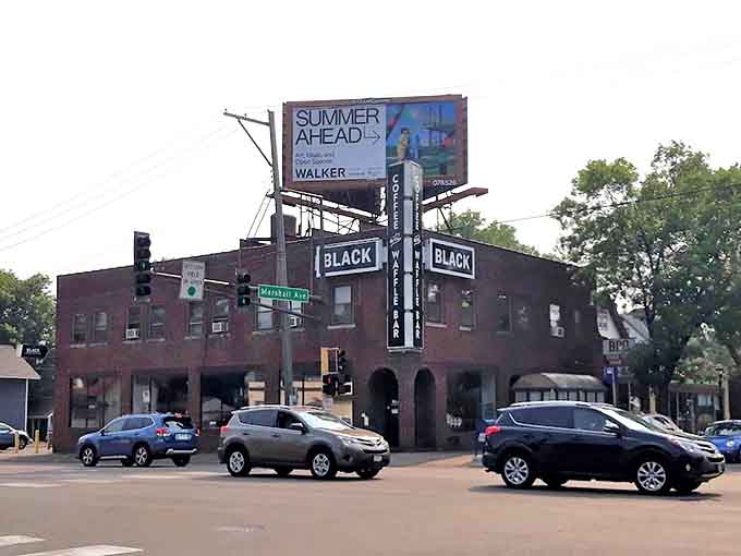 The iconic brick building at Broadway and Central Avenue stands proudly, its arrow sign beckoning waffle enthusiasts like a breakfast lighthouse in Minneapolis.