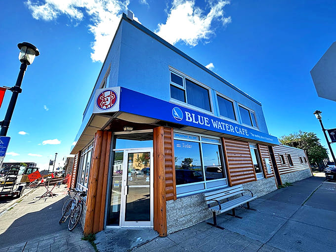 The iconic brick building housing Black Coffee and Waffle Bar stands proudly at the corner, its vintage sign beckoning breakfast enthusiasts from across Minneapolis.