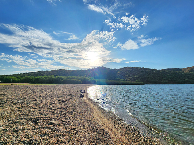 Butcher Jones Beach greets visitors with a sandy shoreline that seems magically transported from the coast to the desert, complete with mountain backdrop.
