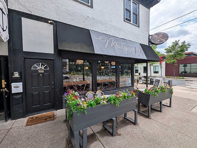 Marguerite's charming storefront beckons with floral planters and a classic black awning, like a Parisian postcard dropped into Minneapolis.