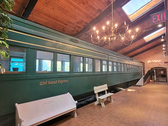 The iconic green "Girl Scout Express" car welcomes diners with vintage charm and elegant chandeliers at Chessie's Restaurant.