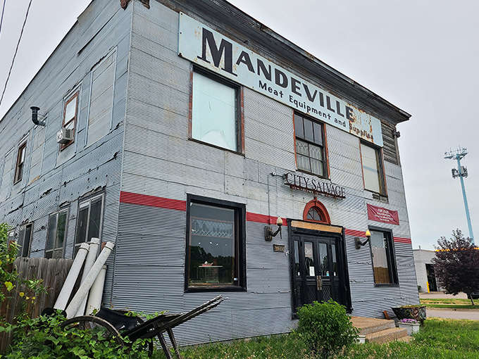 The weathered "MANDEVILLE" sign still crowns City Salvage's facade, a ghost of its meat equipment past now housing architectural treasures instead of butcher supplies.