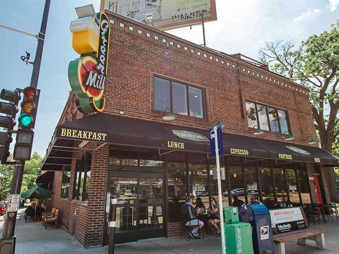 The iconic brick exterior of Colossal Cafe on Grand Avenue beckons breakfast enthusiasts with its vintage sign and promise of pancake perfection.
