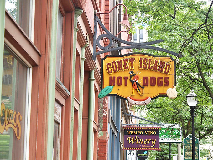 The iconic yellow Coney Island sign hangs proudly against brick, a beacon of culinary tradition since 1915 that's been drawing hungry Kalamazoo locals for generations.