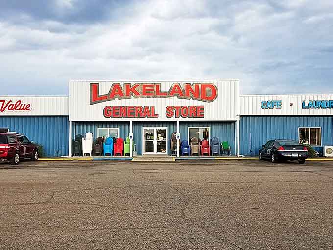 The unassuming blue-and-white exterior of Lakeland General Store hides a culinary wonderland within. Those colorful chairs aren't just sitting pretty!
