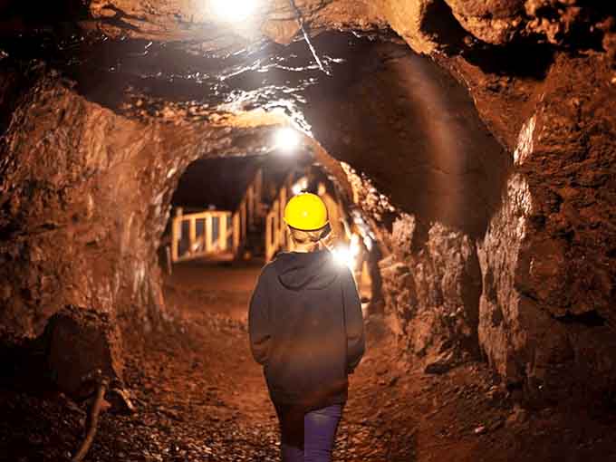 A journey into darkness awaits as visitors don hard hats and descend into Michigan's copper mining past, where history feels tangibly close.