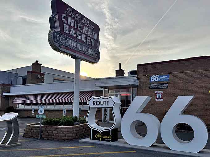Dell Rhea's iconic neon sign stands tall against the twilight sky, a beacon of Route 66 history calling hungry travelers home.