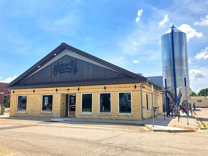 Sunshine bounces off Obscurity's gleaming silver silo, standing sentinel beside the yellow-brick brewhouse like a beacon for thirsty travelers.