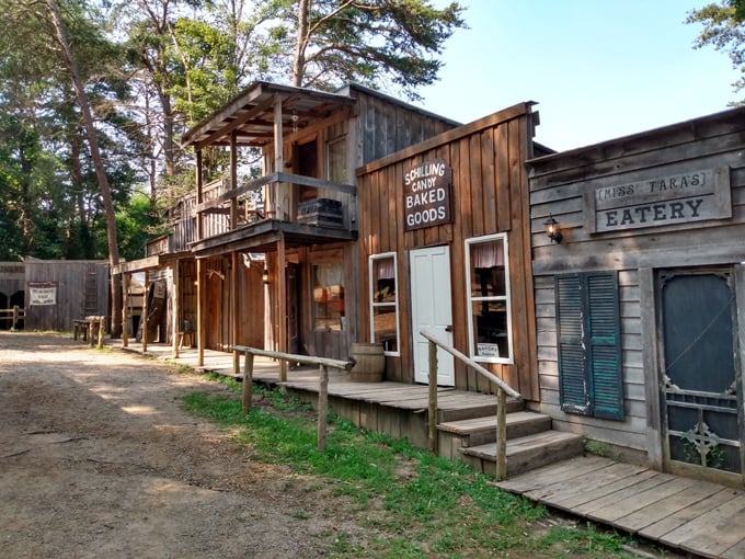 Weathered wooden storefronts line the main street of Dogwood Pass, each board telling its own frontier tale.