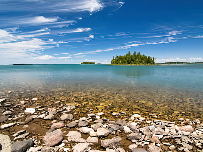 Lake Huron's crystal-clear waters and untouched islands create a view that looks Photoshopped but is gloriously, impossibly real.