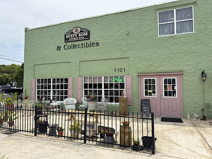 The mint-green facade of Dusty Rose Antique Mall beckons like a colorful oasis of nostalgia on Dunnellon's streetscape.