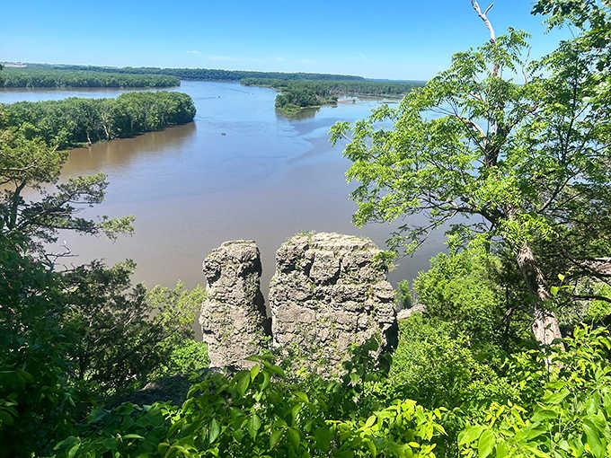 The mighty Mississippi carves its path between ancient limestone bluffs, creating a vista that rivals any national park's grandeur.