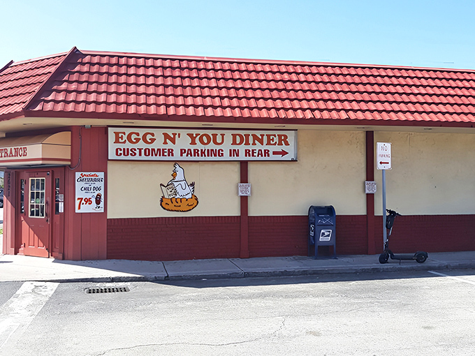 The iconic red-roofed exterior of Egg N' You Diner stands as a beacon of breakfast hope on Fort Lauderdale's busy streets.