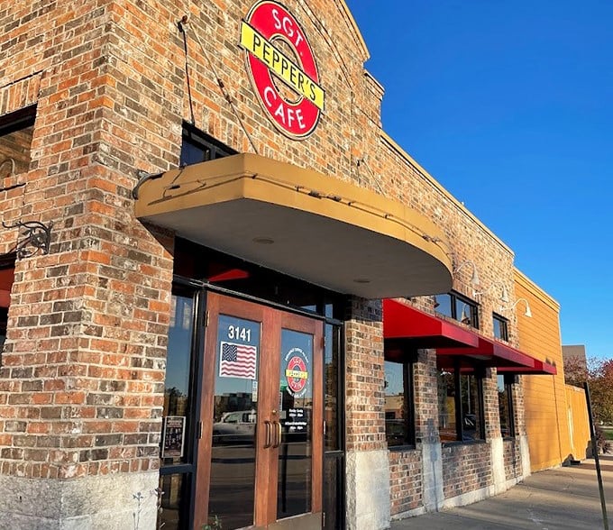 The iconic brick facade of Sgt. Pepper's Cafe stands proudly on Baker Drive, its vibrant red and yellow sign beckoning hungry Beatles fans and food lovers alike.