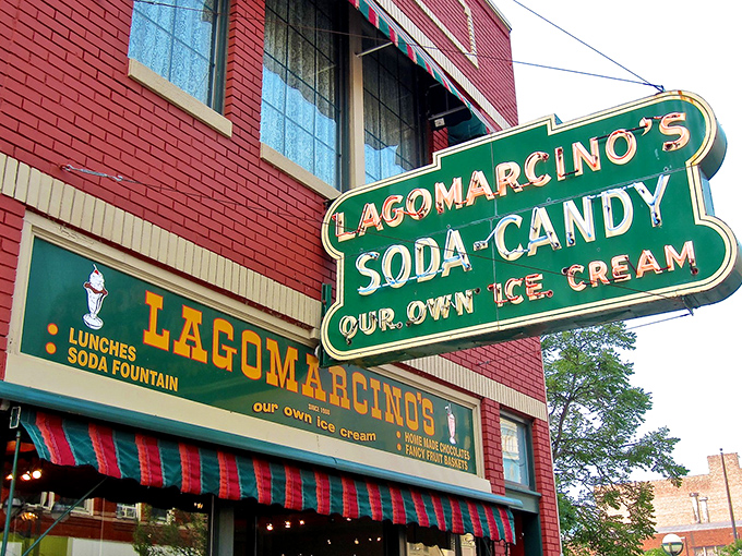 The iconic red brick and striped awning of Lagomarcino's stands as a sweet beacon in downtown Moline, promising nostalgic delights inside.