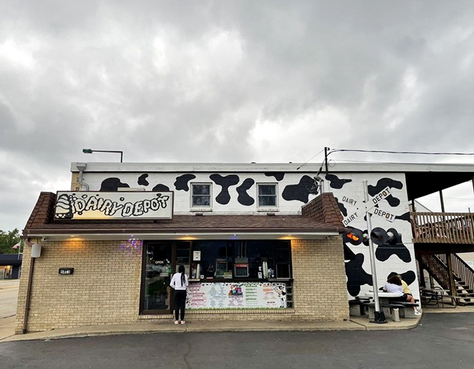 The iconic cow-spotted exterior of Dairy Depot stands like a beacon of frozen delight, promising towering soft serve adventures to all who approach.