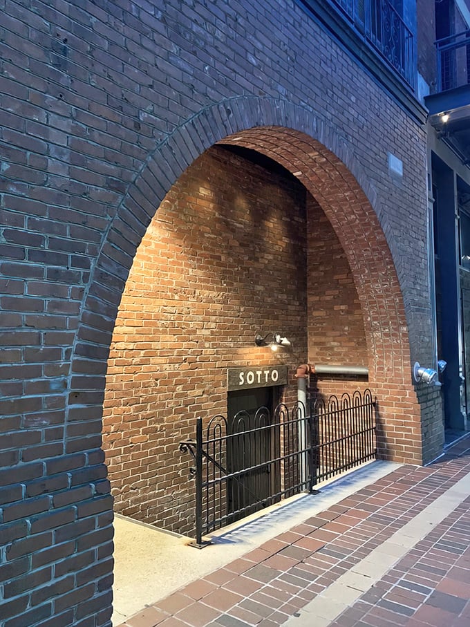 The mysterious entrance to Sotto beckons from beneath a brick archway &ndash; your first clue that culinary adventure awaits below Cincinnati's streets.