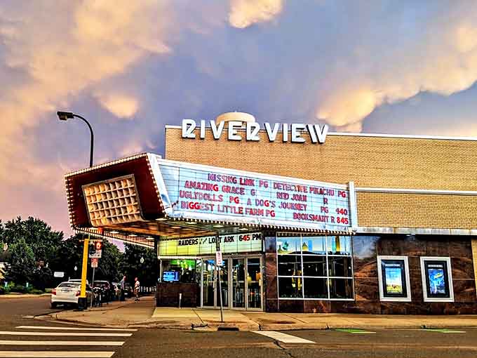 The iconic Riverview marquee glows against the Minneapolis sky, a mid-century beacon promising cinematic adventures within those brick walls.