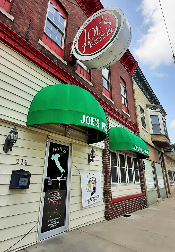 The iconic storefront beckons with its vintage charm &ndash; that red and white sign promising pizza perfection inside those brick walls.