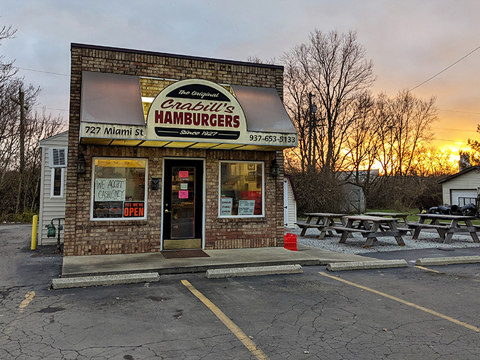 Sunset casts a golden glow on Crabill's brick exterior &ndash; a humble time capsule of American burger culture standing proudly since 1927.
