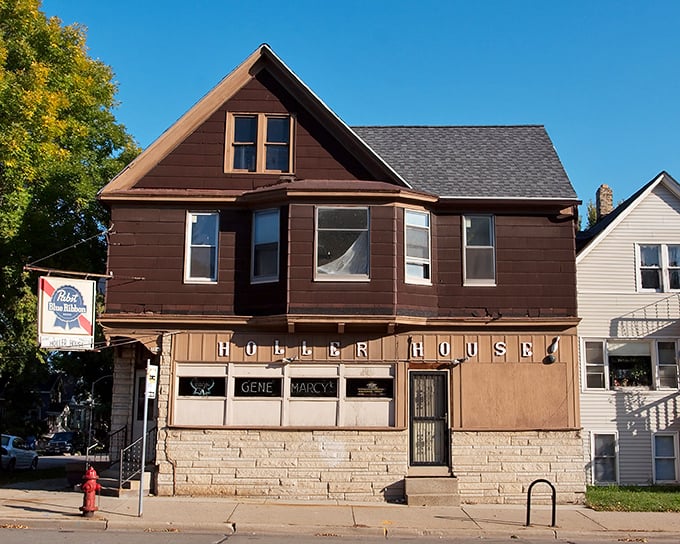 The unassuming exterior of Holler House hides a century of Milwaukee history behind its modest brown facade and vintage sign.