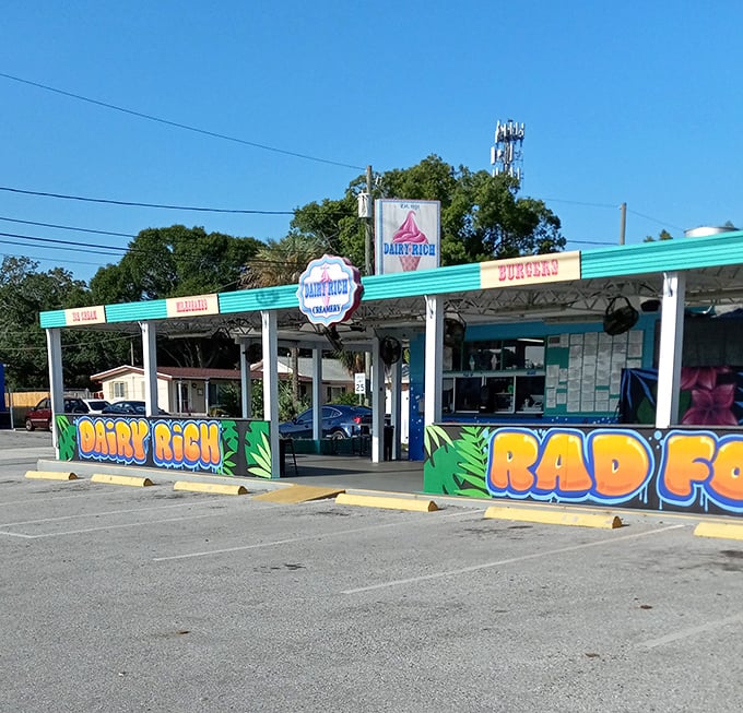 The turquoise-trimmed Dairy Rich stands like a tropical oasis in St. Petersburg, its vibrant murals promising sweet relief from Florida heat.