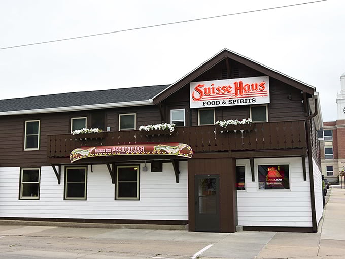 The welcoming facade of Suisse Haus stands proudly in Monroe, its red sign glowing like a beacon for hungry travelers.