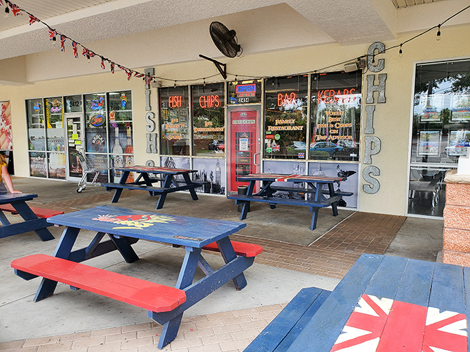 The cheerful exterior of Sunday's Grill beckons with patriotic picnic tables and twinkling lights, a British oasis amid Florida's palm trees.