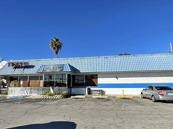 The iconic blue-roofed exterior of Papa's New York Diner stands as a beacon of comfort food in Clearwater, promising 24-hour breakfast bliss to hungry travelers.
