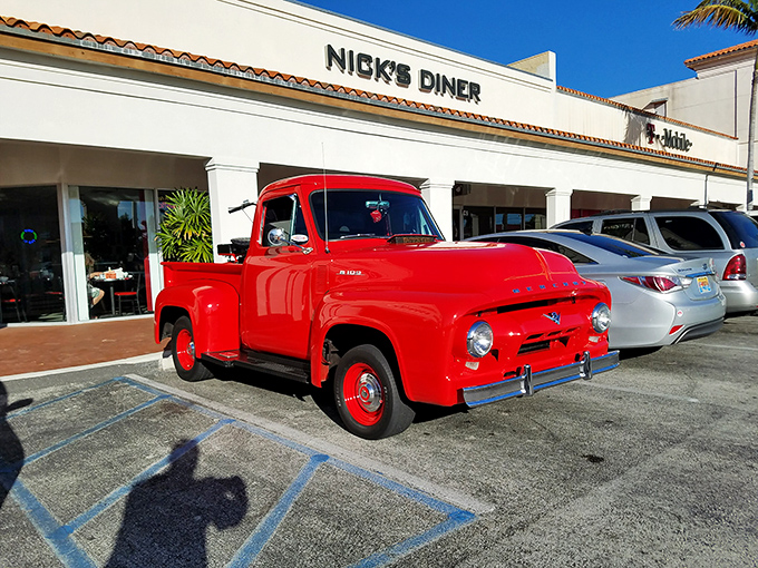 A classic cherry-red vintage pickup truck greets visitors outside Nick's Diner &ndash; a perfect ambassador for the nostalgic journey awaiting inside.