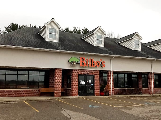 That green chameleon logo beckons you into a world where pizza meets Middle-earth in suburban Kalamazoo splendor.