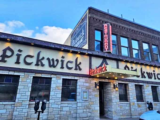 The iconic stone facade of Pickwick Restaurant stands proudly on Superior Street, its vintage neon sign beckoning hungry travelers like a lighthouse for the famished.