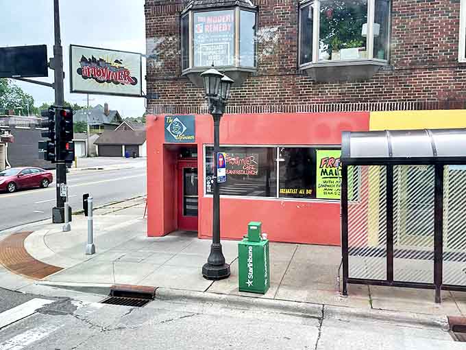 The unmistakable red facade of The Uptowner beckons hungry patrons like a breakfast lighthouse on Grand Avenue's busy corner.
