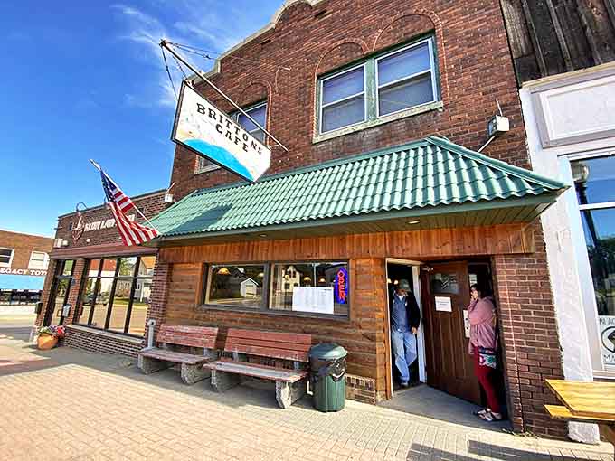 Britton's Caf&eacute; welcomes hungry travelers with its charming brick exterior, green awning, and wooden benches that practically whisper "come on in."