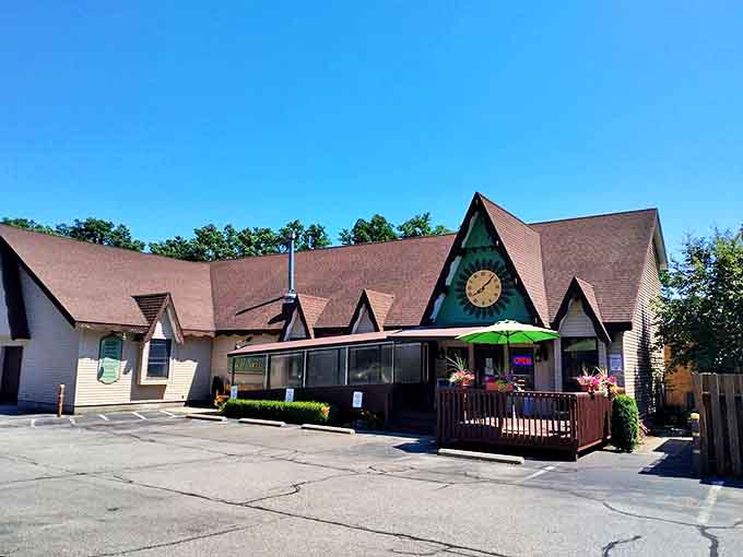 Exterior: A charming cottage-like bakery with a distinctive sunflower clock perched above the entrance &ndash; Switzerland meets Midwest in architectural harmony.
