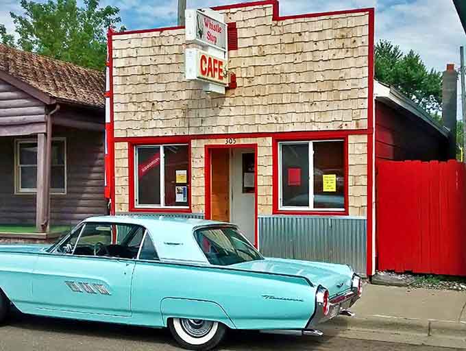 A classic American diner dream with red-trimmed wooden shingles and that iconic "CAFE" sign &ndash; plus a vintage Thunderbird that seems to know where the good food lives.