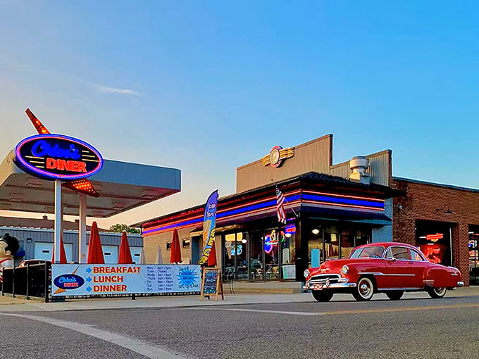 Chloe's Diner glows with vintage charm as the neon sign beckons hungry travelers. That classic red car isn't just for show&mdash;it's setting the stage for what awaits inside.