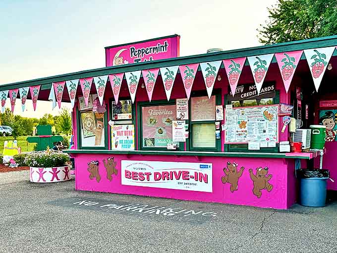 The hot pink facade of Peppermint Twist stands out like a beacon of summer joy, complete with dancing teddy bear mascots and colorful pennants.