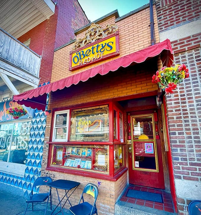 O'Betty's vibrant storefront beckons with its red awning and cheerful flowers, like a colorful wink on an otherwise ordinary street.