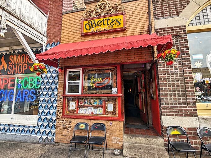 O'Betty's vibrant storefront beckons with its red awning and neon hot dog sign &ndash; a theatrical entrance promising culinary adventures beyond the ordinary.