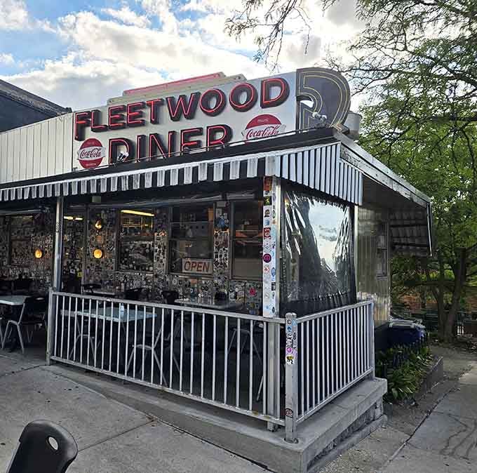 The iconic silver exterior of Fleetwood Diner beckons with its vintage charm and bold red signage &ndash; Ann Arbor's 24-hour beacon for the hungry.