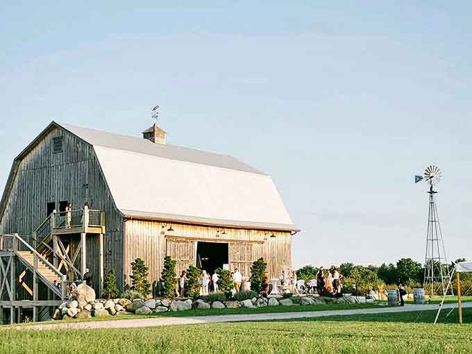 A weathered barn transformed into wine country elegance, where rustic charm meets sophisticated sipping in Michigan's picturesque Leelanau Peninsula.