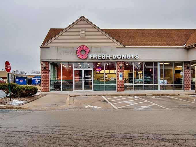 The unassuming storefront with its cheerful pink donut sign promises simple pleasures that deliver beyond expectations.