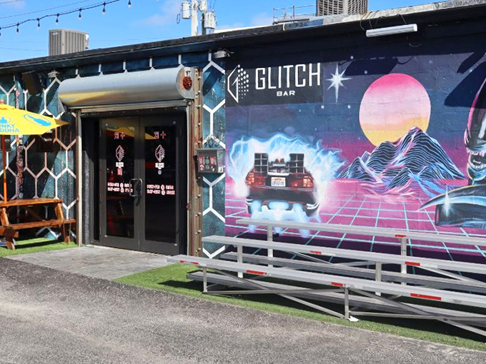 Glitch Bar's exterior bursts with neon energy, featuring a DeLorean mural that practically screams "1985 called and wants you to have the time of your life."
