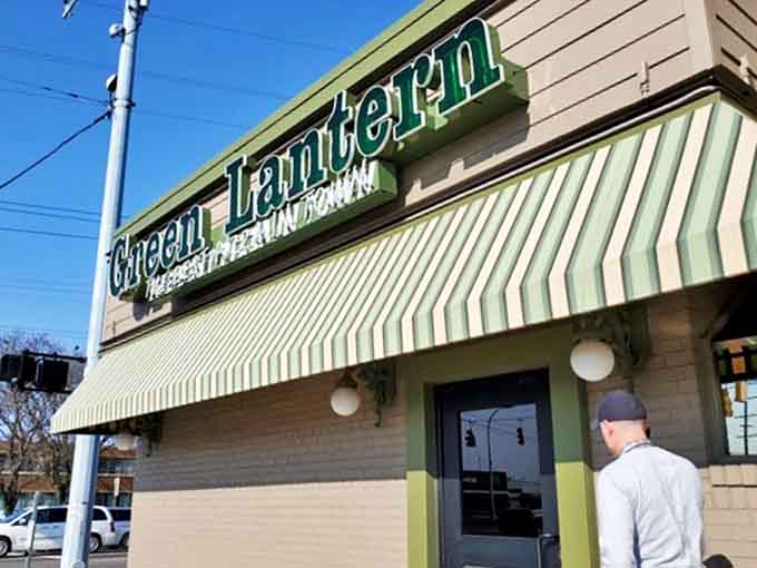 The iconic green lantern pizza sign promises "THE BEST PIZZA IN TOWN" &ndash; a bold claim they've been backing up since 1955.