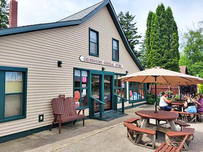 The Grindstone General Store stands proud in its classic cream and green trim, looking like it stepped straight out of a Norman Rockwell painting with better ice cream.