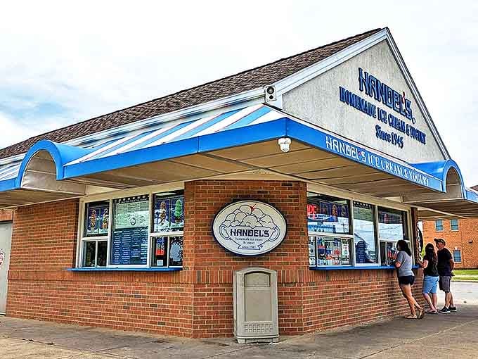 The iconic blue-trimmed building stands like a sweet oasis, promising frozen bliss since 1945 to anyone wise enough to stop.